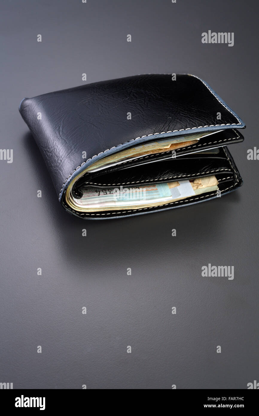 stock image of the wallet full of money Stock Photo - Alamy