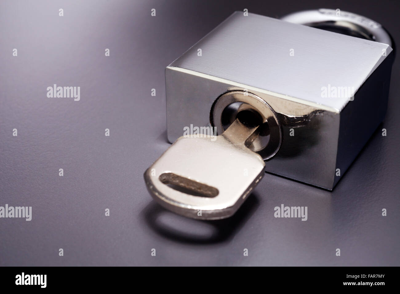 Padlock with key isolated on background Stock Photo - Alamy