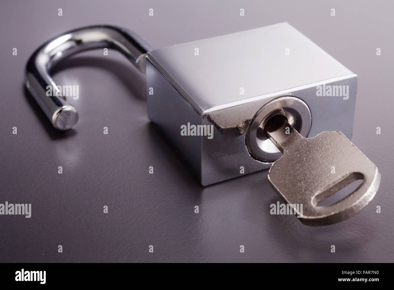 Padlock with key isolated on background Stock Photo - Alamy
