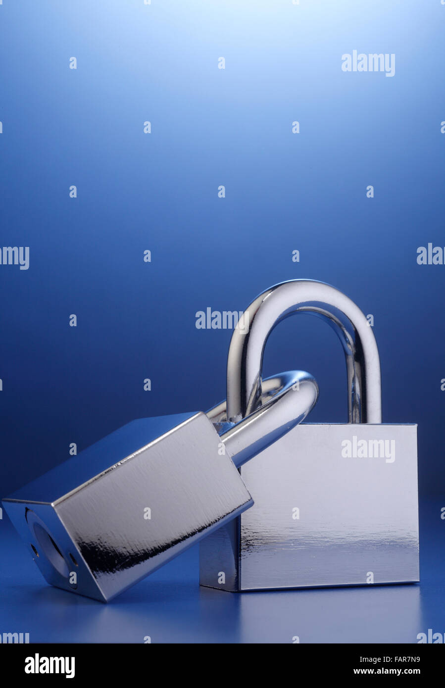Two padlocks interlocked together on the background Stock Photo - Alamy