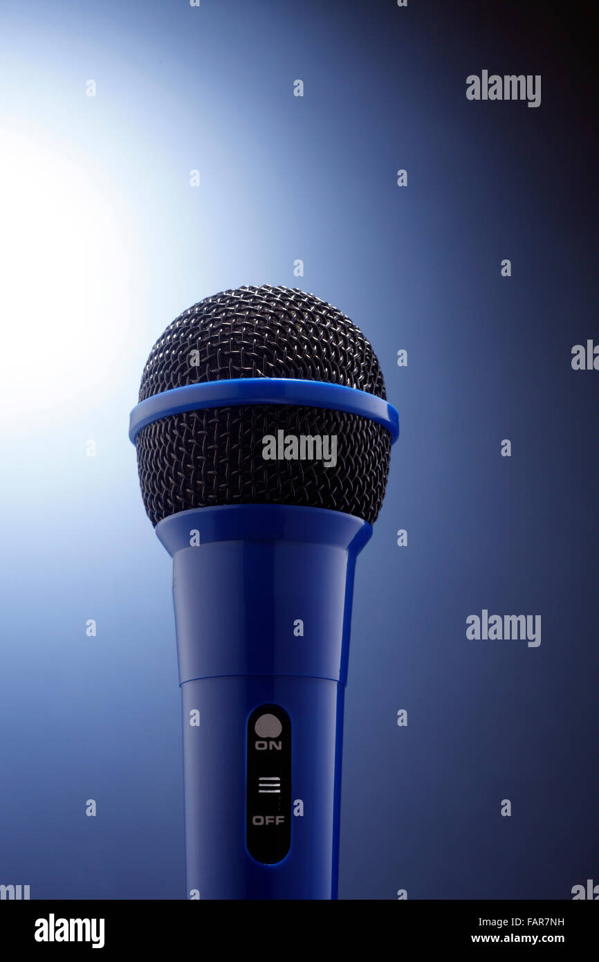 Blue microphone isolated on the background Stock Photo - Alamy