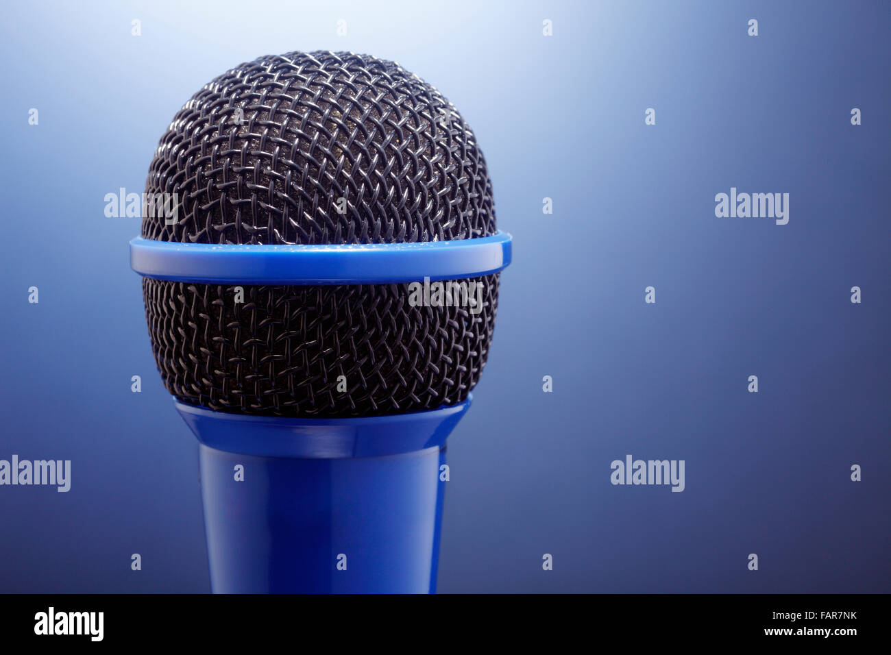 Blue microphone isolated on the background Stock Photo - Alamy