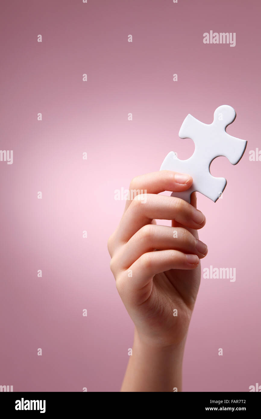 Human hand holding puzzle piece Stock Photo - Alamy