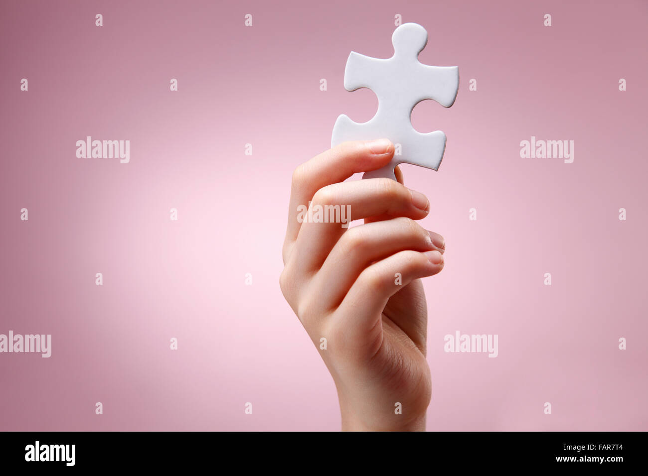 Human hand holding puzzle piece Stock Photo - Alamy