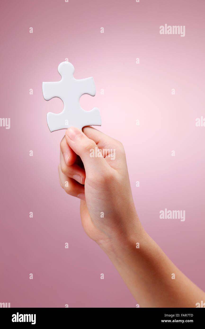 Human hand holding puzzle piece Stock Photo - Alamy