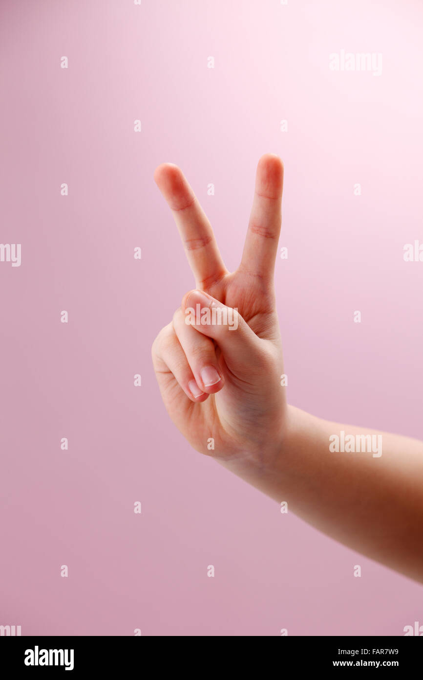 Human hand showing victory sign Stock Photo - Alamy