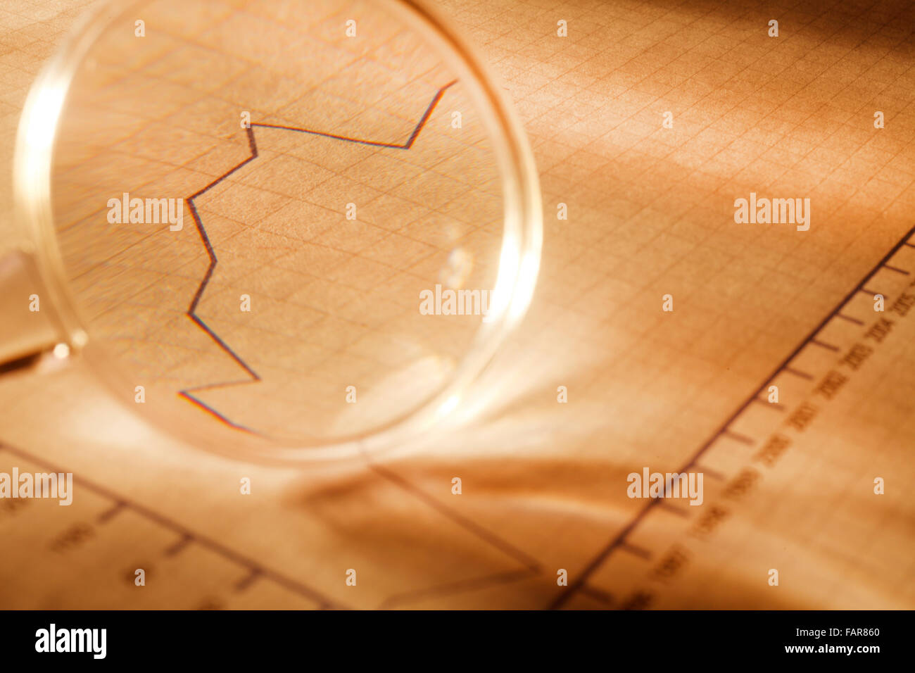 stock image of the magnifier glass on the chart Stock Photo - Alamy