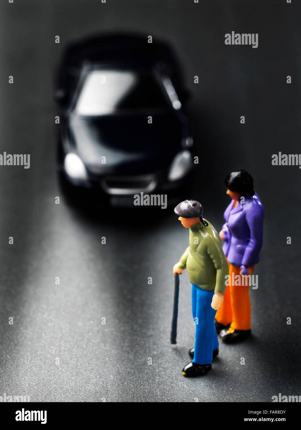 miniature old couple cossing road very slow Stock Photo - Alamy