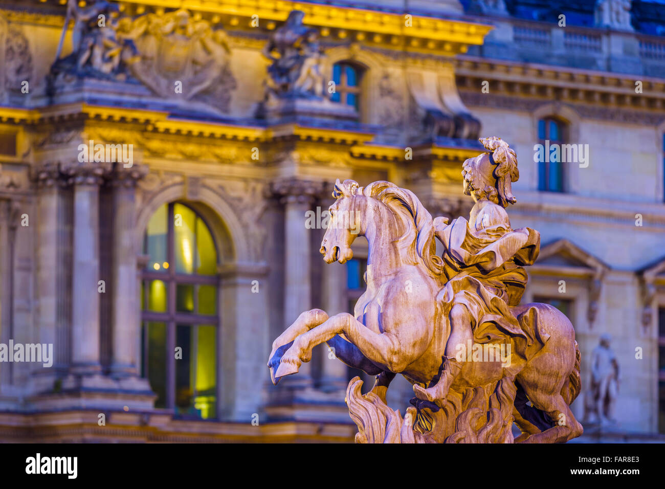 Louvre Museum courtyard with statue at dusk, Paris Stock Photo - Alamy