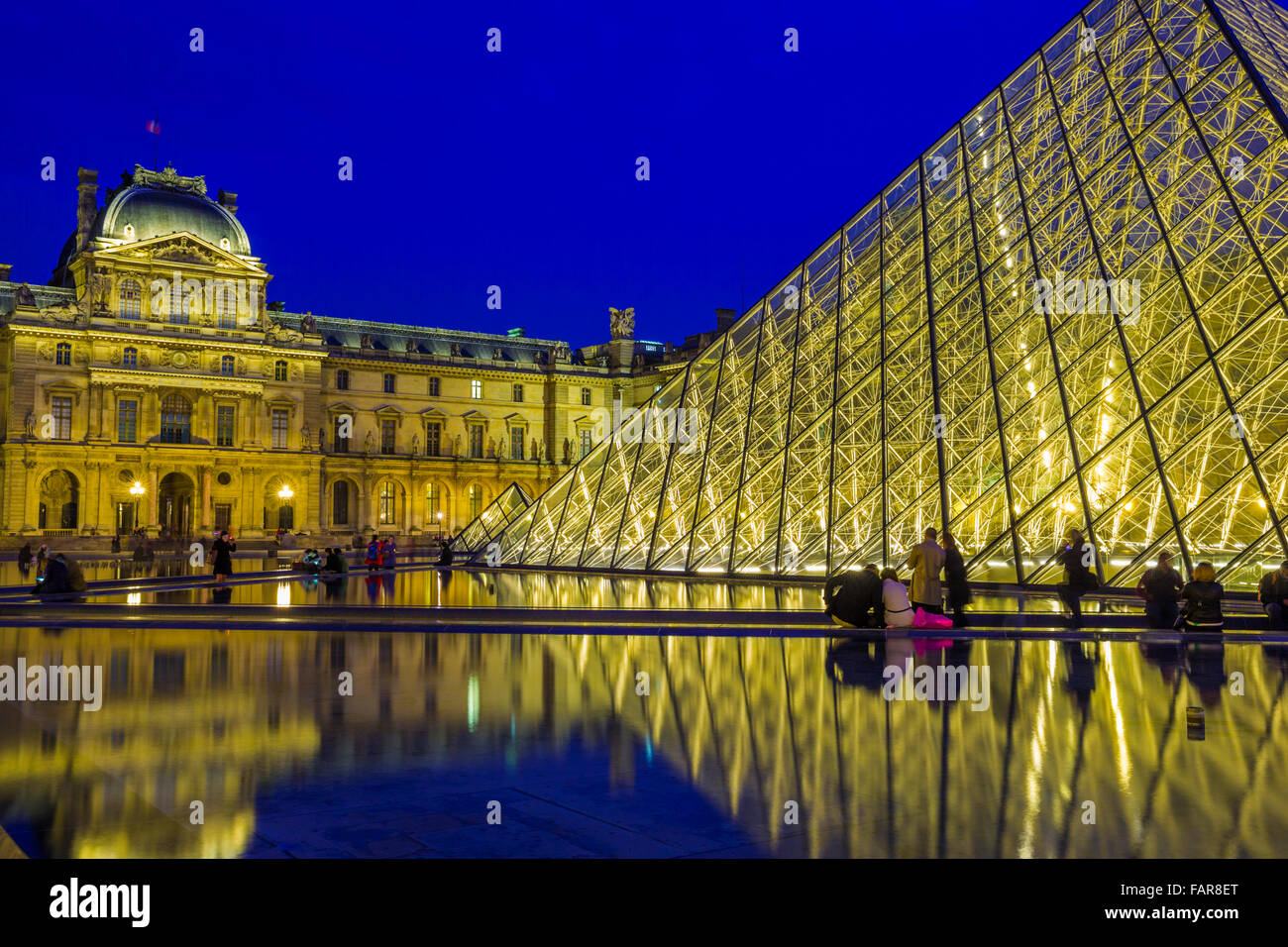 Louvre Museum main entrance and fountains at dusk, Paris Stock Photo ...