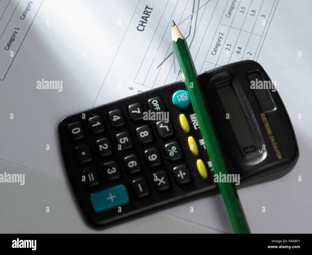 chart and calculator on the table Stock Photo - Alamy