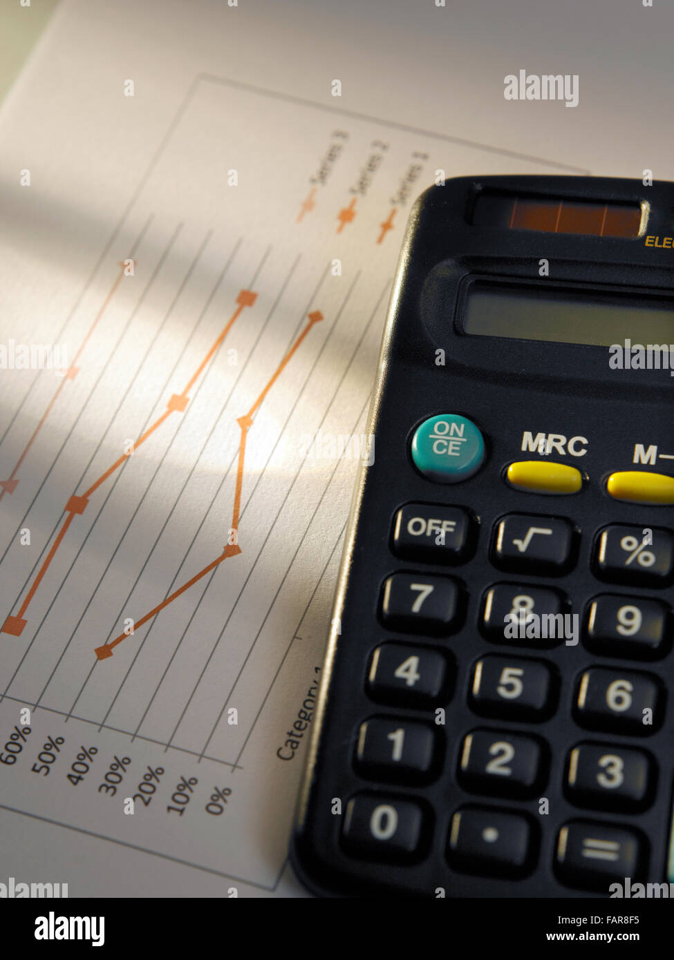 chart and calculator on the table Stock Photo - Alamy