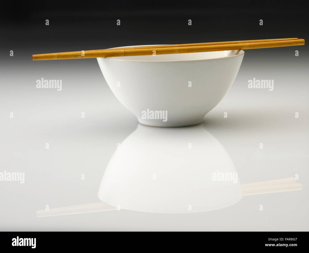 chockstick rest on the bowls on the plain background Stock Photo - Alamy