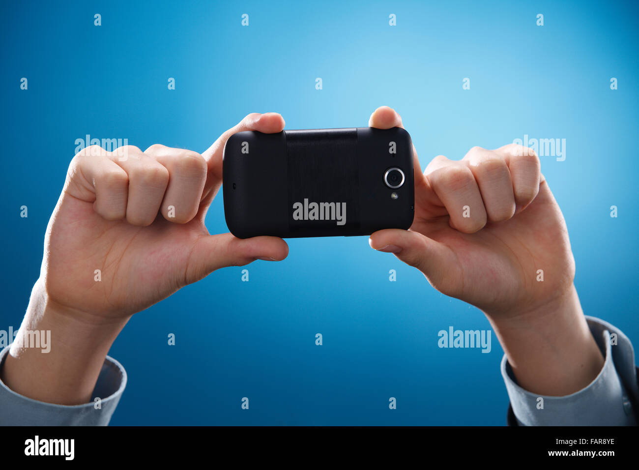 Human hands holding a cell phone Stock Photo - Alamy