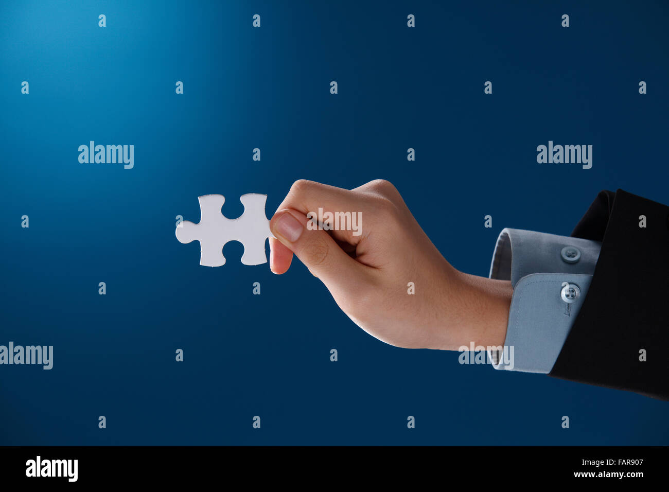 Human hand holding a jigsaw piece Stock Photo - Alamy
