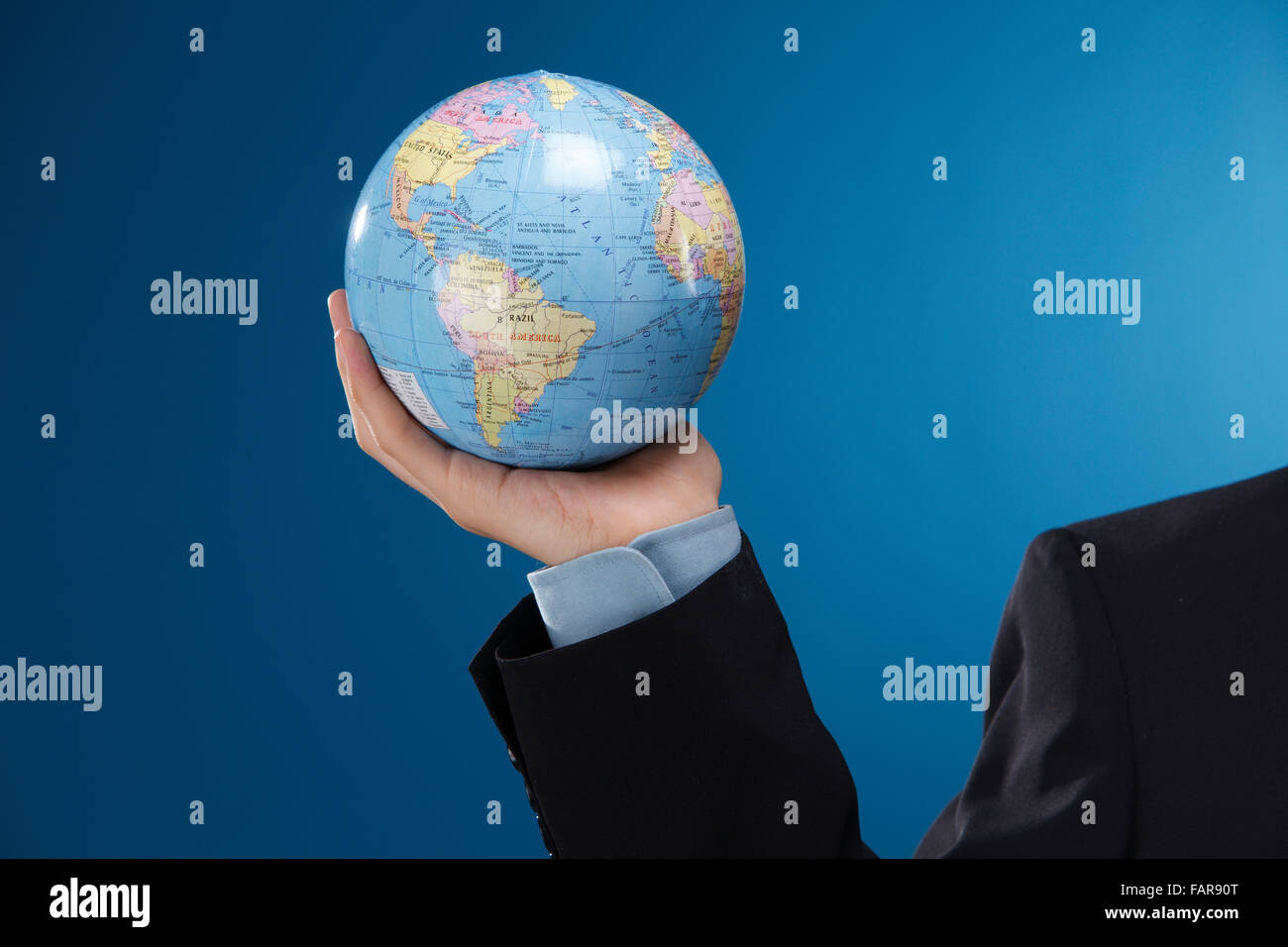Human hand holding a globe Stock Photo - Alamy