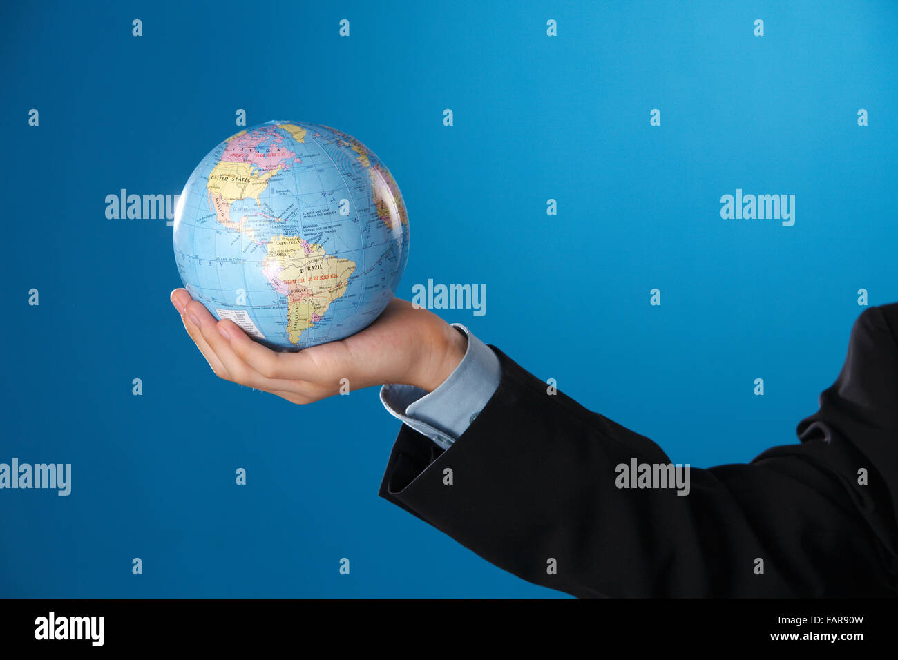 Human hand holding a globe Stock Photo - Alamy