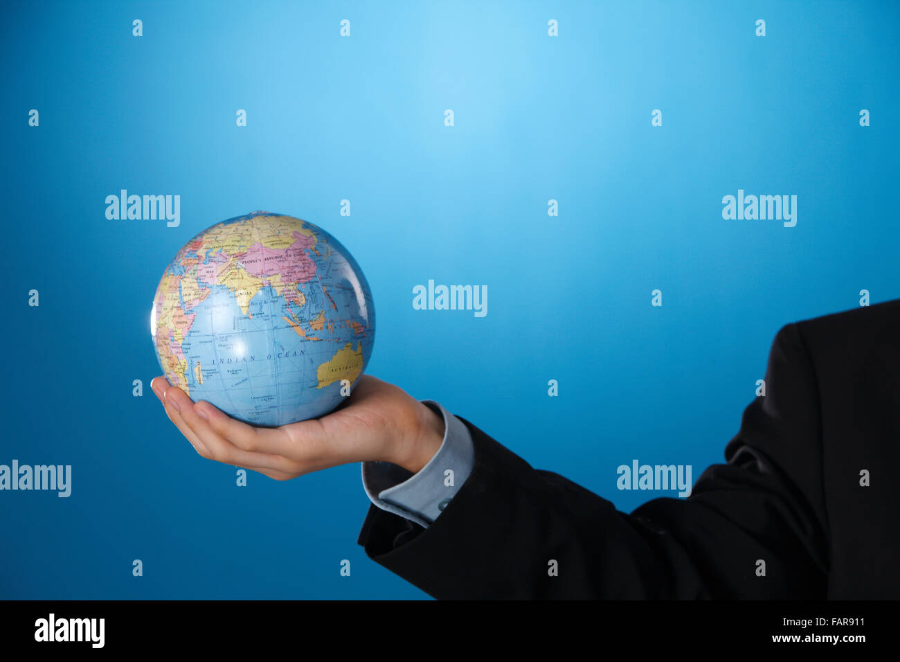 Human hand holding a globe Stock Photo - Alamy