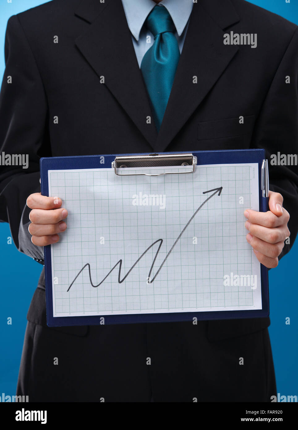 Human holding a graph attached to a clipboard Stock Photo - Alamy