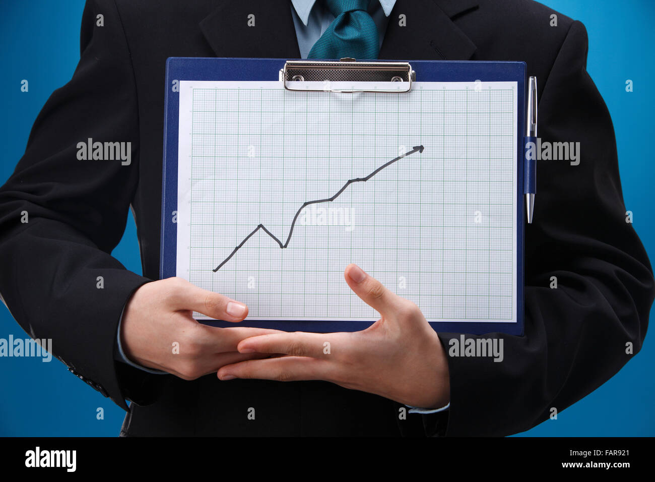 Human holding a graph attached to a clipboard Stock Photo - Alamy