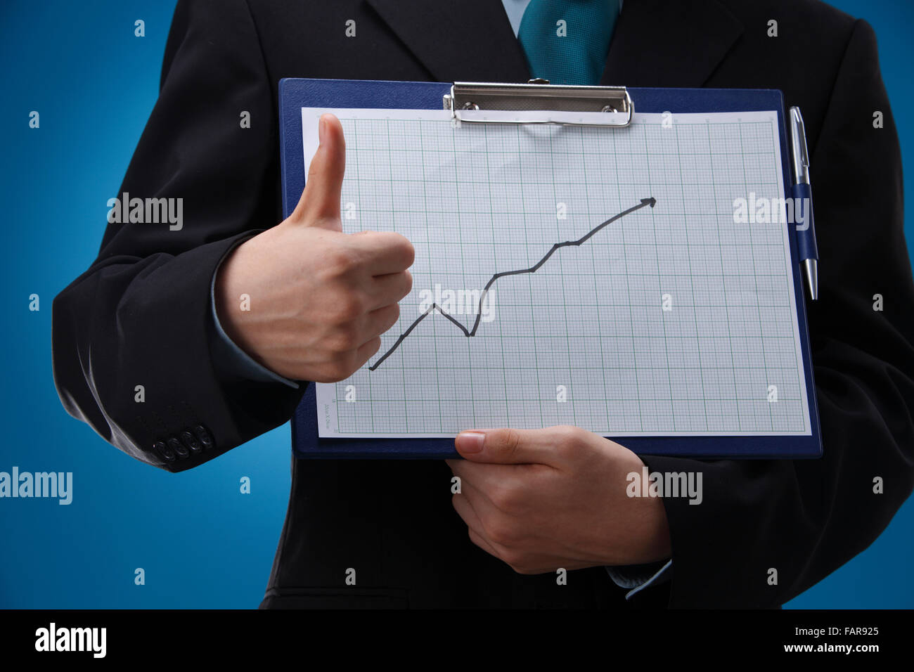 Human holding a graph attached to a clipboard Stock Photo - Alamy