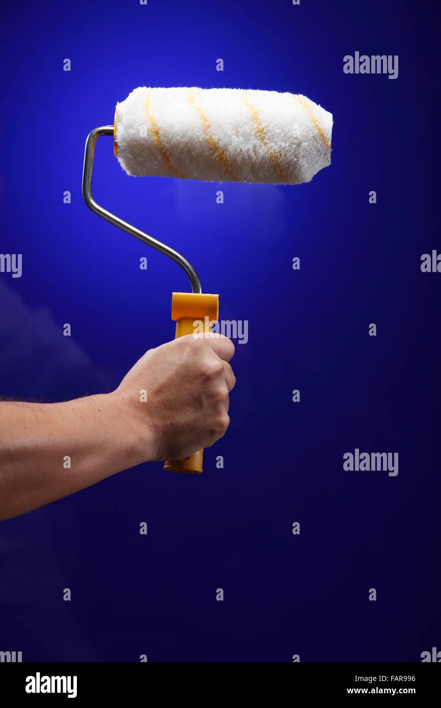 Human hand holding a paint roller Stock Photo - Alamy