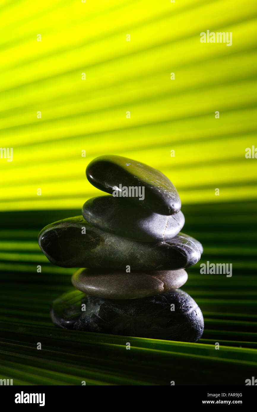 Stack of stones on the green leaf Stock Photo - Alamy