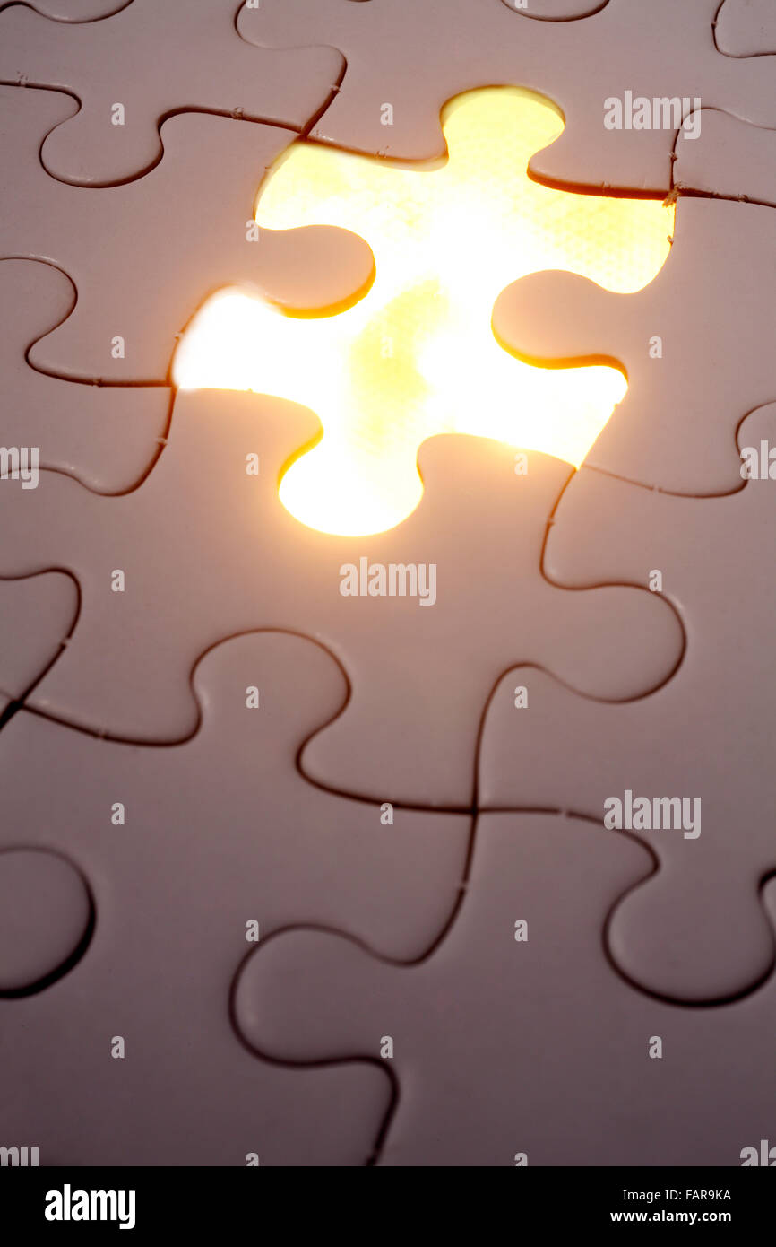 Light shining out of a missing puzzle piece Stock Photo - Alamy