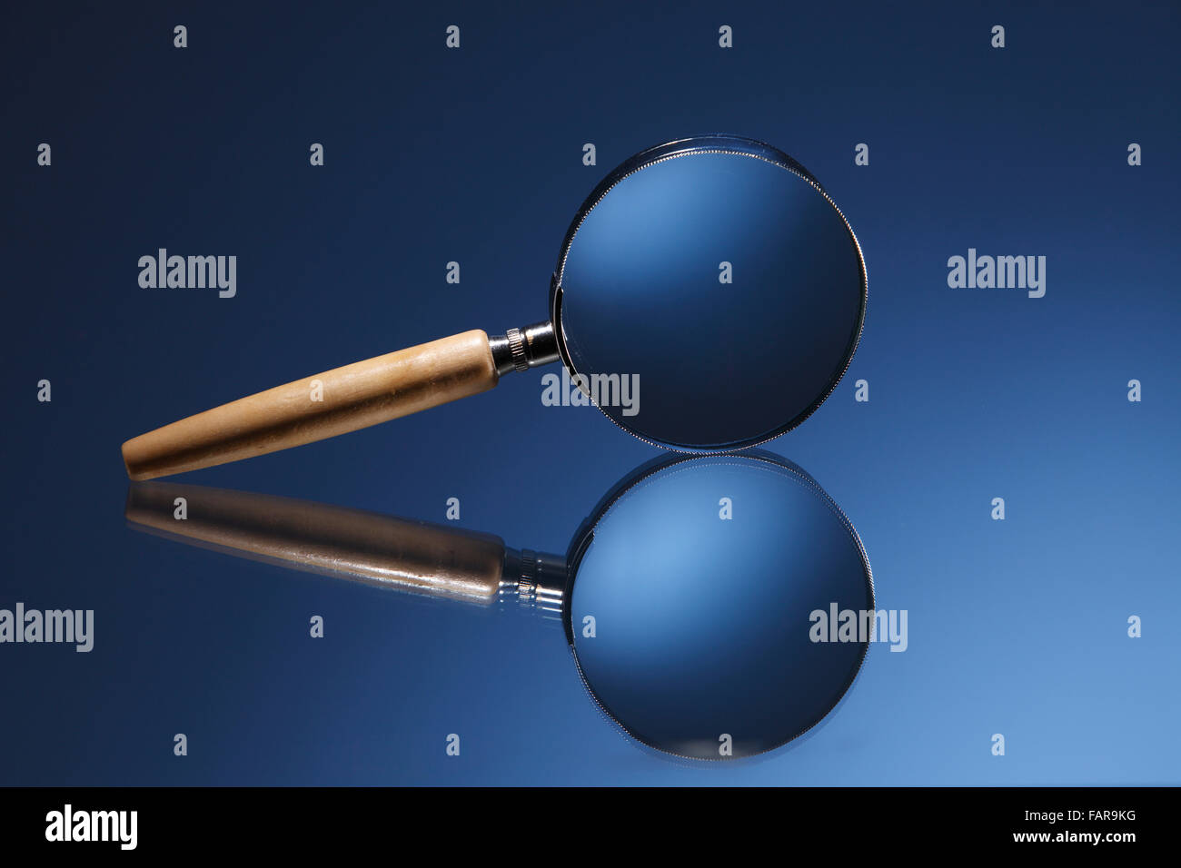 Magnifier isolated on the blue background Stock Photo - Alamy