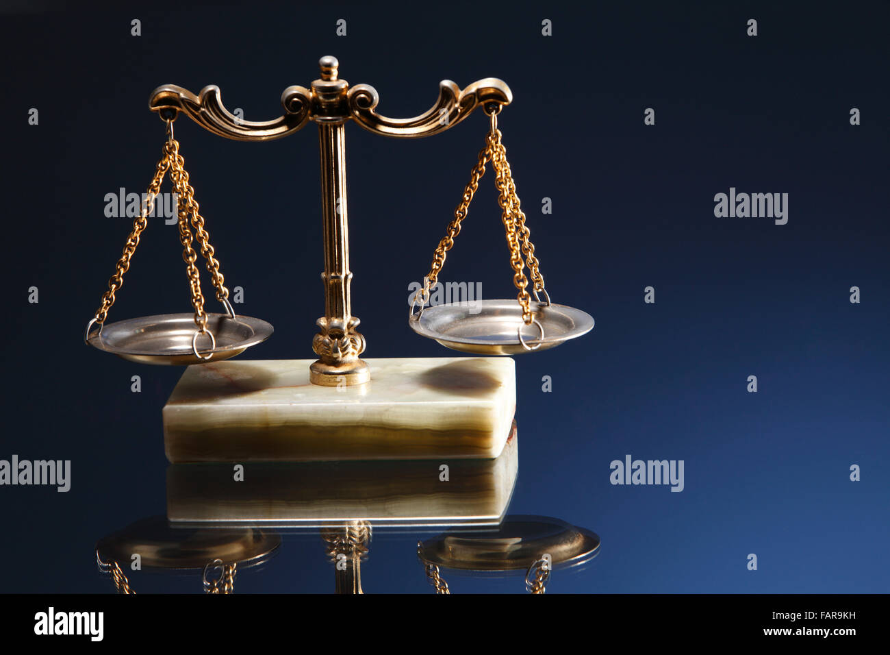 Balance scale isolated on the blue background Stock Photo - Alamy