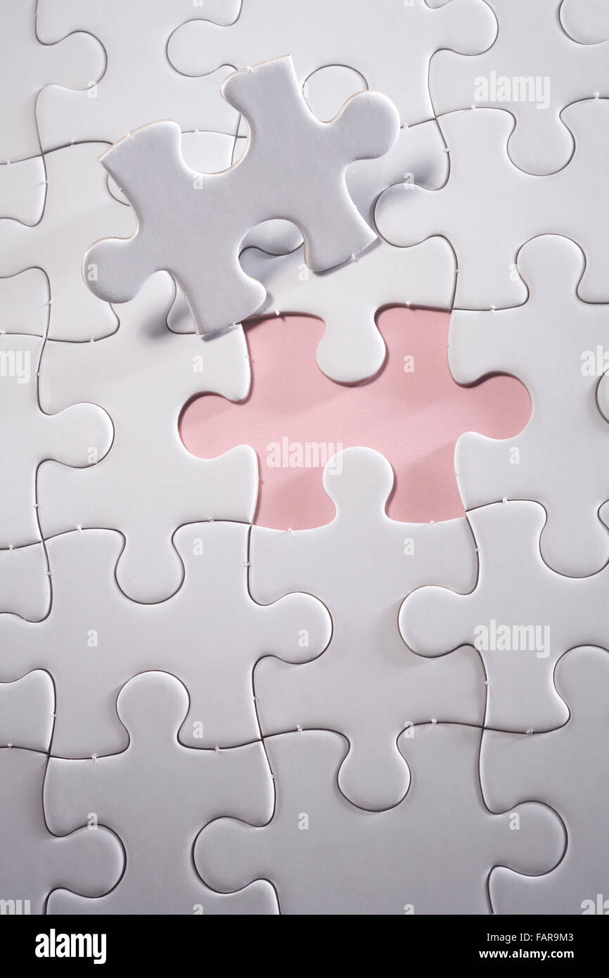 Final puzzle piece waiting to be put in Stock Photo - Alamy