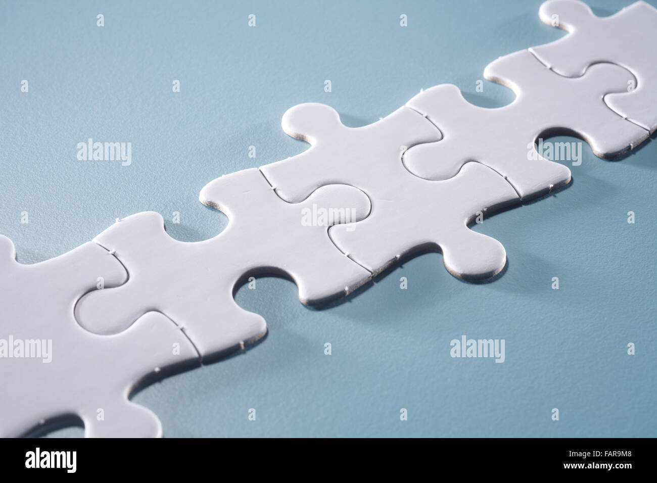 Jigsaw puzzle arranged into a line Stock Photo - Alamy