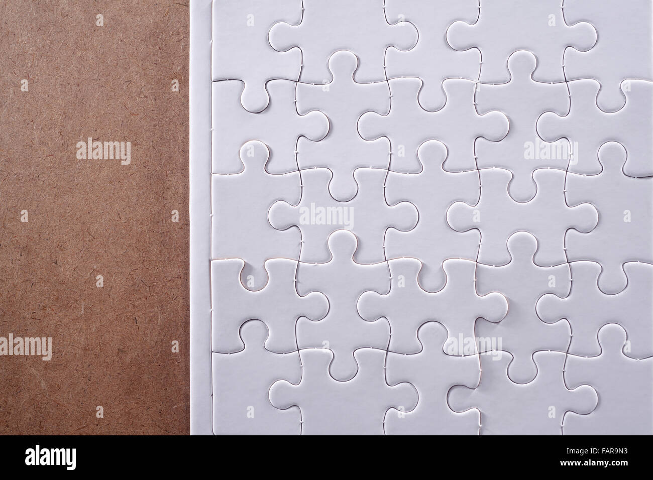 Completed jigsaw puzzle isolated on wooden table Stock Photo - Alamy