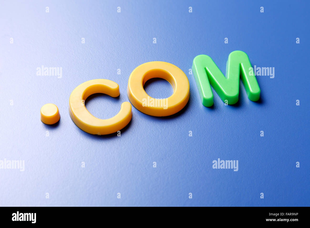 Magnetic alphabets arranged into ".com Stock Photo - Alamy