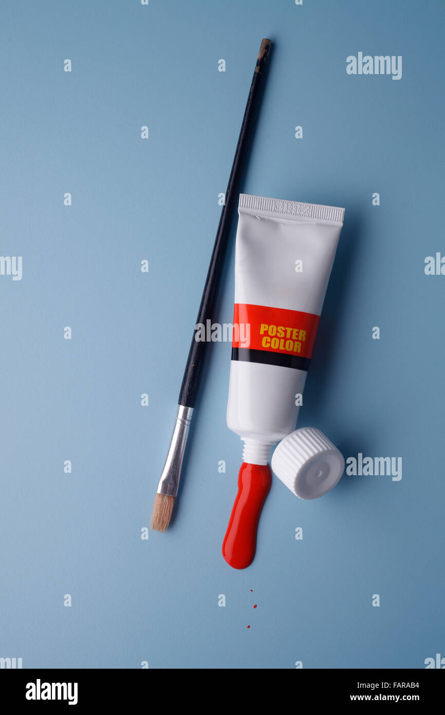 Paintbrush with a tube of paint isolated on blue background Stock Photo ...