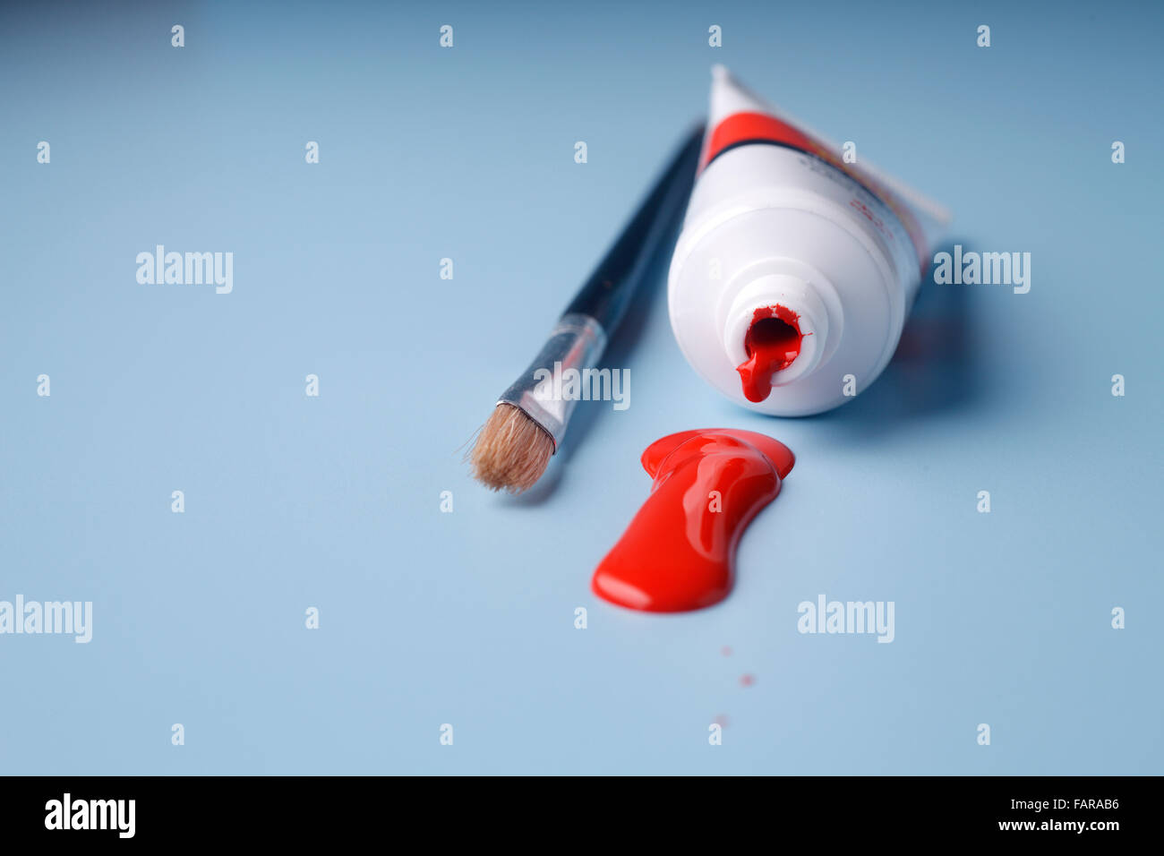 Paintbrush with a tube of paint isolated on blue background Stock Photo ...