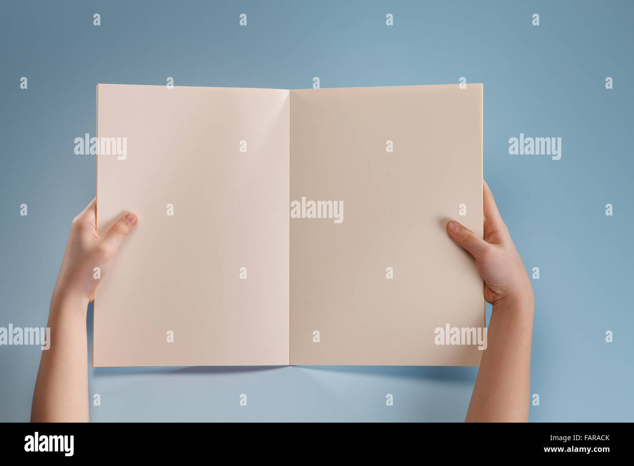 Human hands holding a book Stock Photo - Alamy