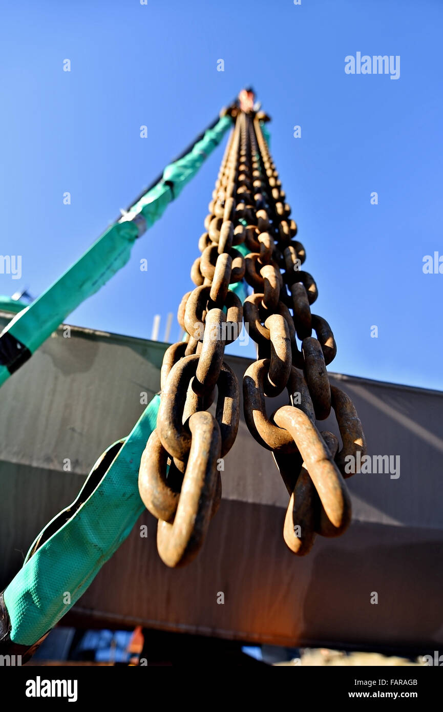 Heavy duty industrial chain hooked up on a construction crane Stock ...