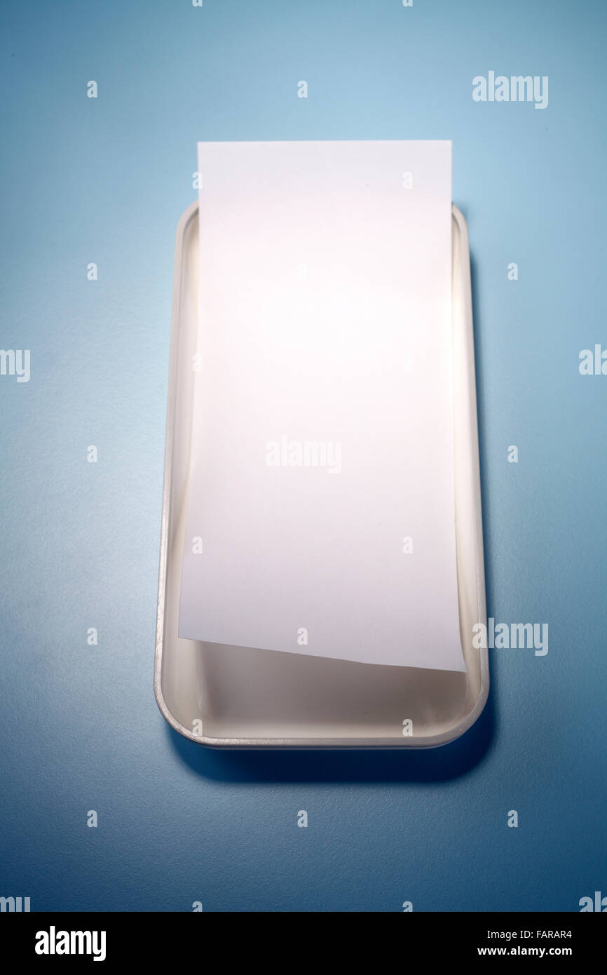 blank Reciept and tray isolated on blue background Stock Photo - Alamy