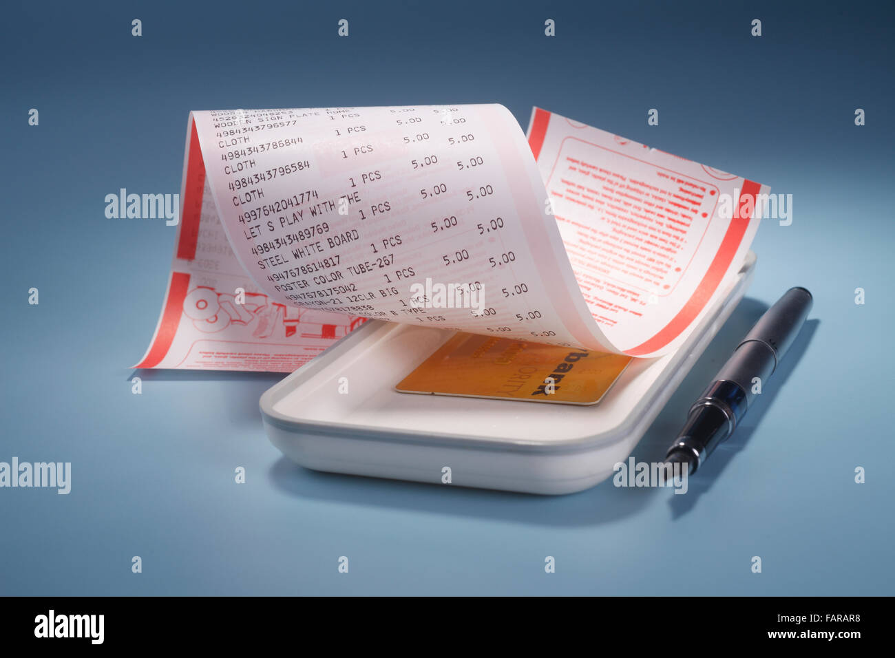 Credit card with reciept isolated on blue background Stock Photo - Alamy