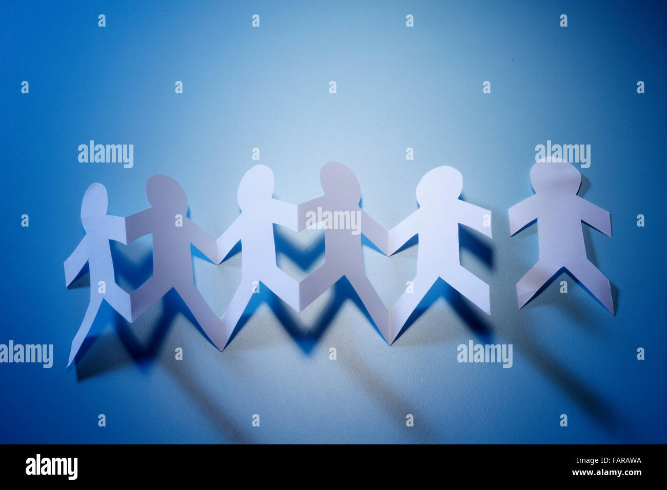 Paper chain holding hands together waiting other to join Stock Photo ...