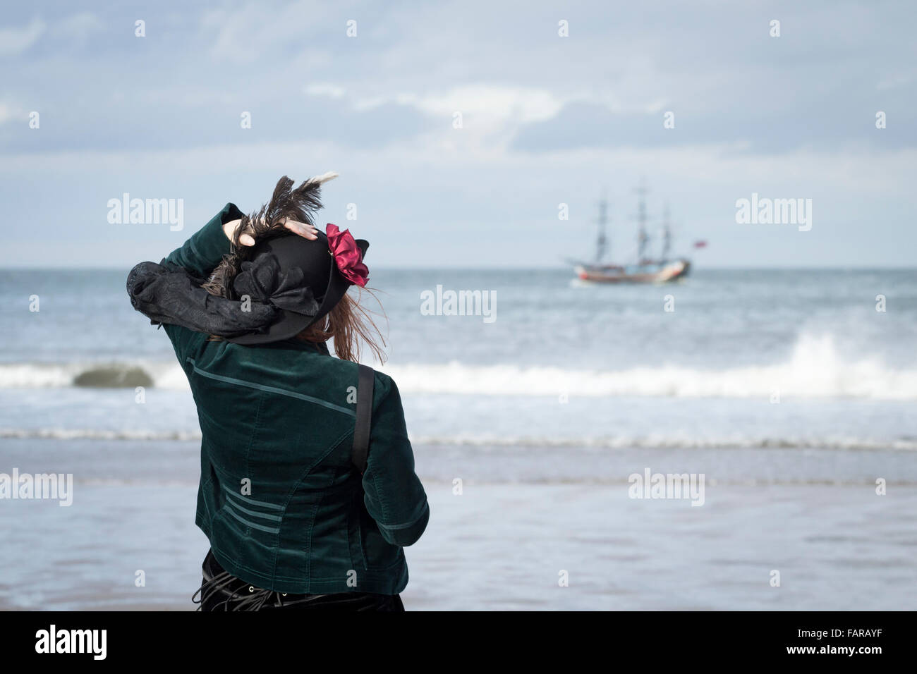 Goth looking out to sea from Whitby beach during Whitby Goth festival ...