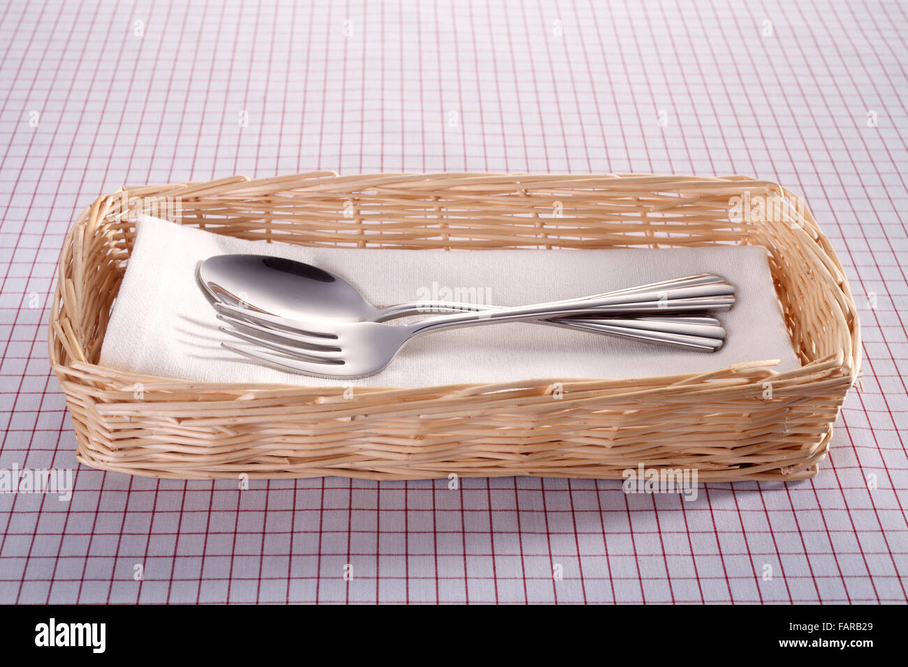 Fork and spoon in a rattan basket Stock Photo - Alamy
