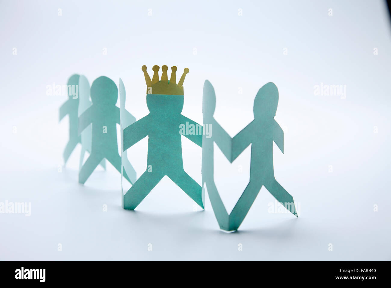 Paper chain holding hands together Stock Photo - Alamy