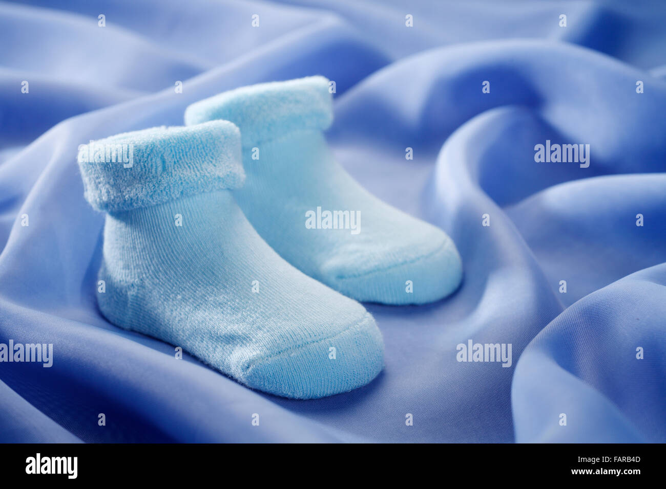 Blue socks isolated on a blue cloth Stock Photo - Alamy
