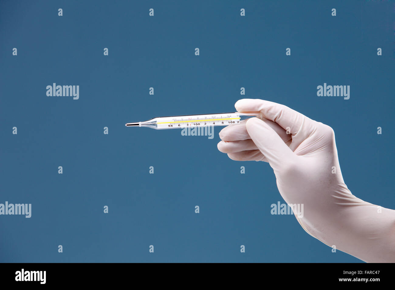 Hand holding thermometer for reading Stock Photo - Alamy