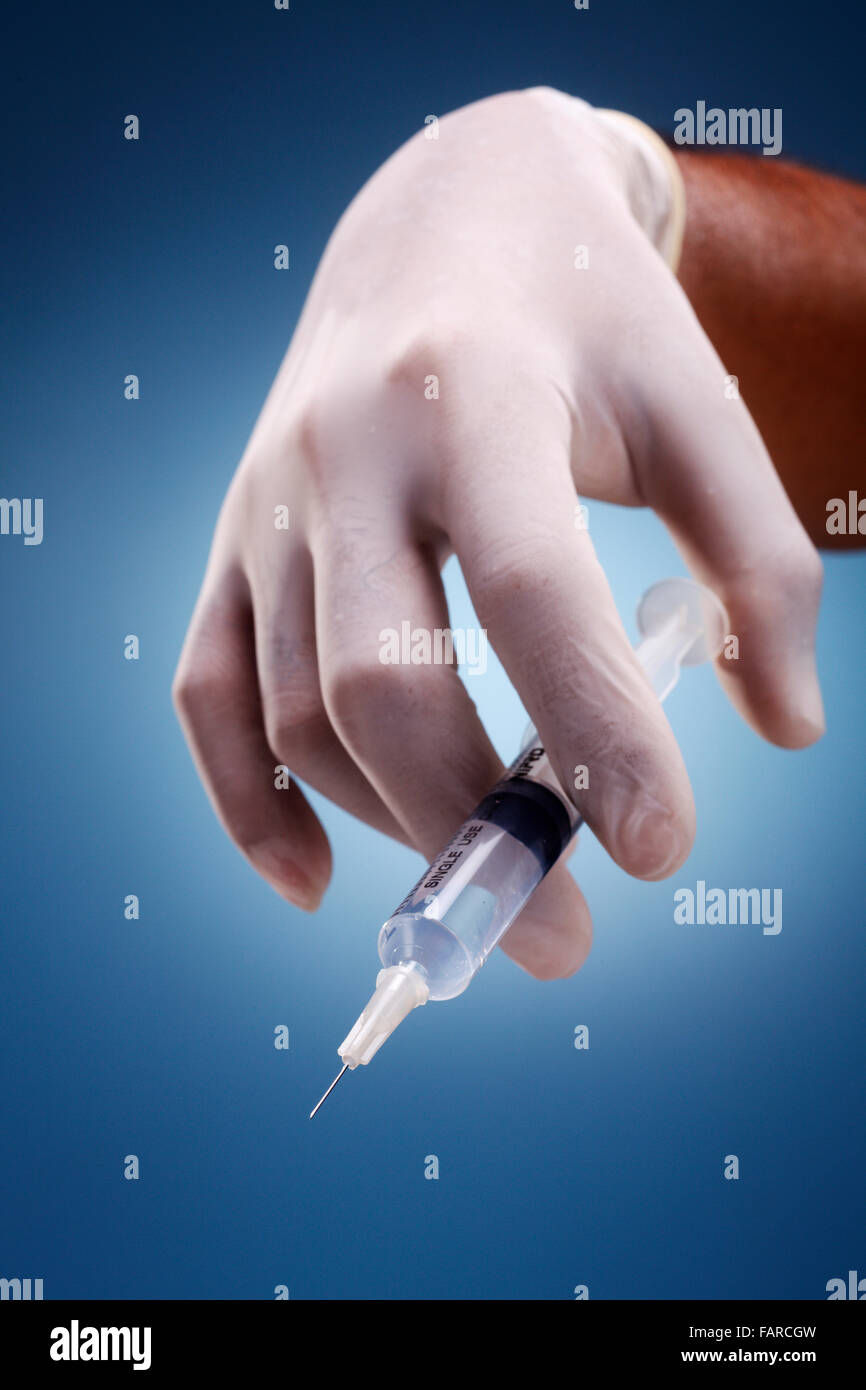 A person holding a syringe Stock Photo - Alamy