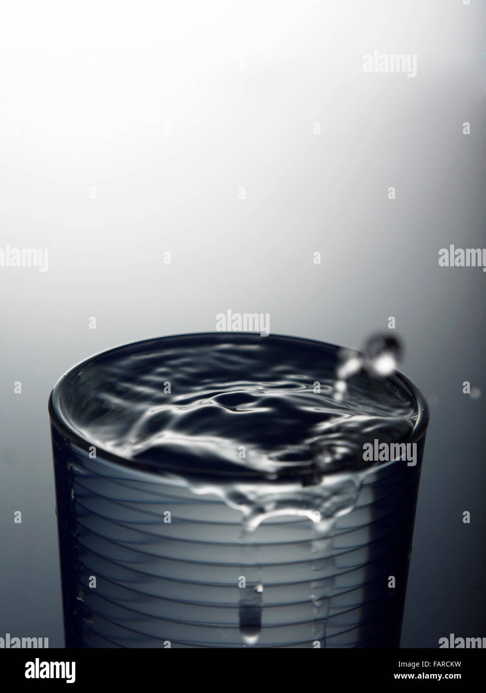 Water splashing out of a cup Stock Photo - Alamy