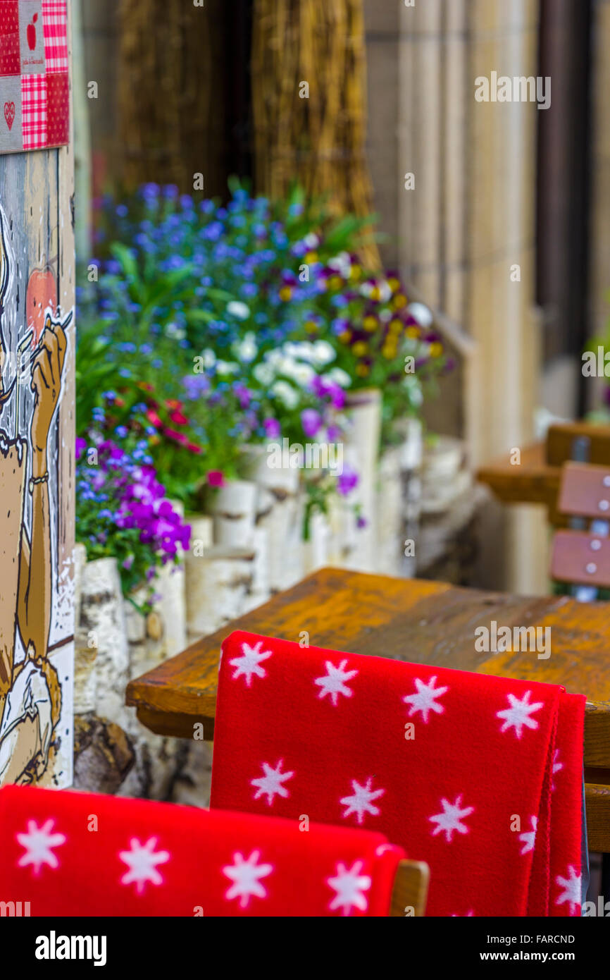 Outdoor restaurant seating with blankets and flower box in Colmar ...