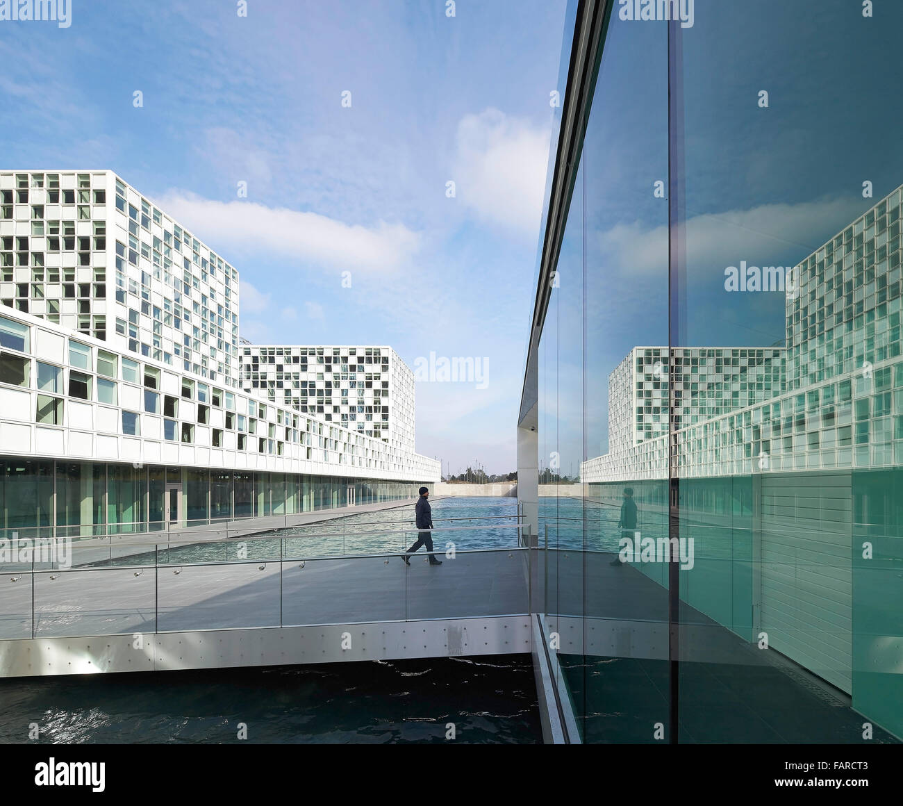 Perspective of office towers with moat-style pond and bridge ...